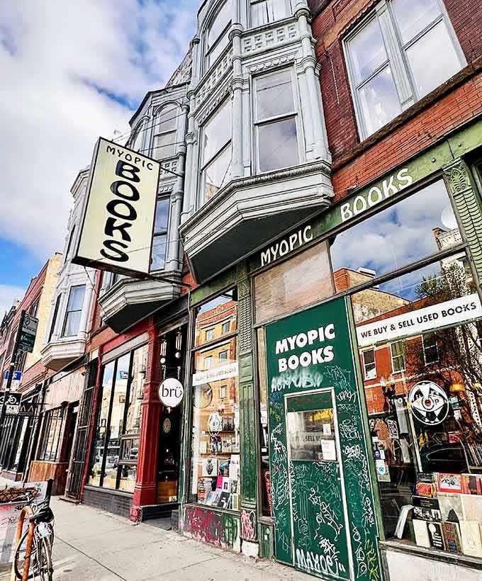 The vintage signage and weathered brick create a streetscape that feels authentically lived-in, not manufactured for Instagram.