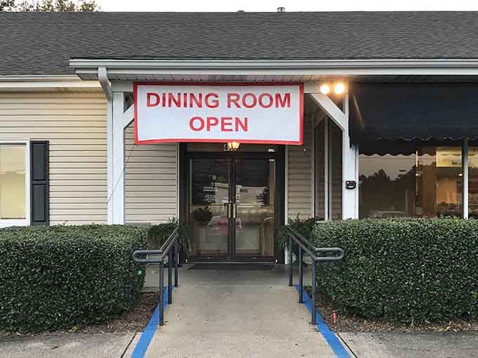 The unassuming entrance to Paw Paw Patch beckons with Southern simplicity. Like finding a secret doorway to comfort food paradise, this banner promises delicious things await inside.