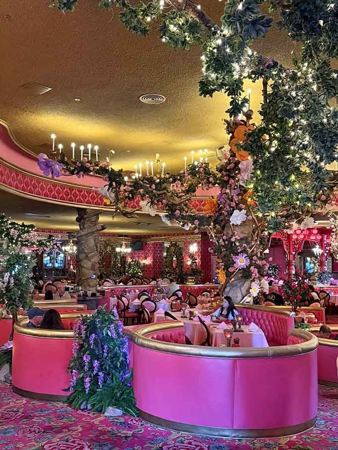 Those circular pink booths are basically saying "sit here and feel fancy" while chandeliers twinkle overhead like edible arrangements came to life.