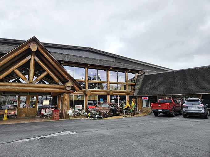 Grumpy's impressive timber-framed entrance stands like a cathedral of collectibles, with vintage vehicles serving as quirky greeters in the parking lot.
