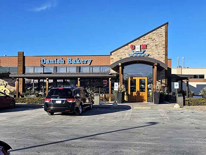 A Danish Bakery with a charming covered entrance beckons hungry travelers under brilliant blue skies—pastries and possibilities await inside.