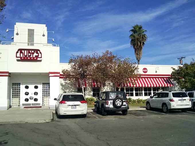 The red-and-white striped awning practically waves you inside like a friendly grandmother with fresh-baked cookies waiting.