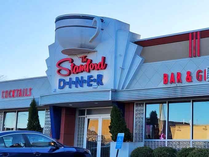 The iconic coffee cup sign atop The Stamford Diner isn't just architectural flair—it's a beacon of breakfast hope for hungry Connecticut travelers.