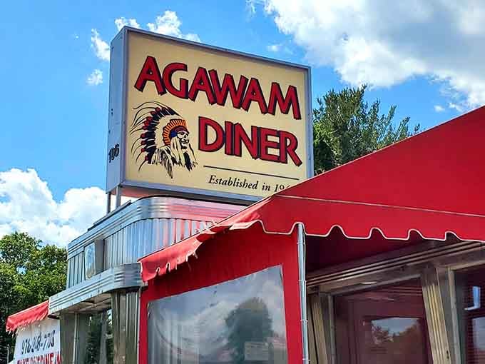 That classic Native American chief logo against the bright blue sky isn't just a sign&mdash;it's a beacon of breakfast hope for generations of Massachusetts families seeking authentic diner magic.
