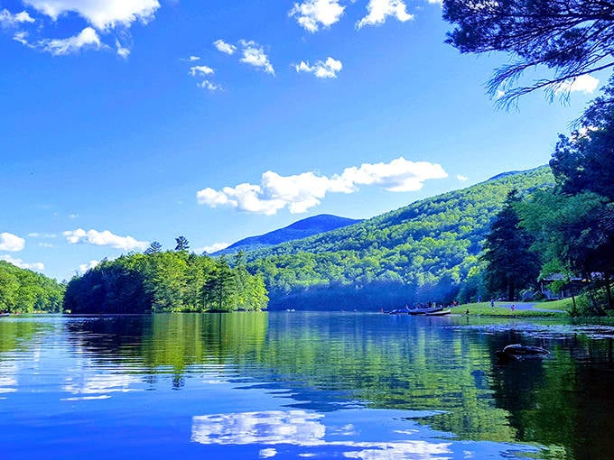 Summer perfection at Emerald Lake, where crystal-clear waters reflect the brilliant blue sky and verdant mountains of East Dorset.
