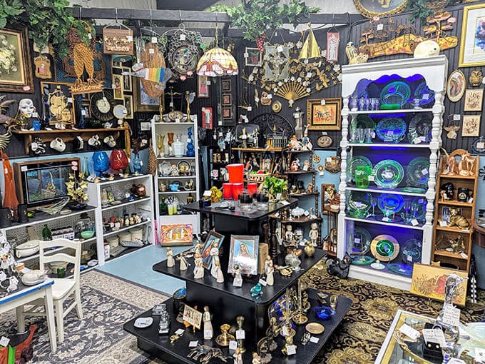 A treasure hunter's paradise! This vendor booth overflows with collectibles, from vibrant glassware to delicate figurines and vintage decor.
