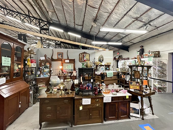 Elegant antique furniture displays create an inviting showroom of timeless craftsmanship, with cabinets and tables from bygone eras.