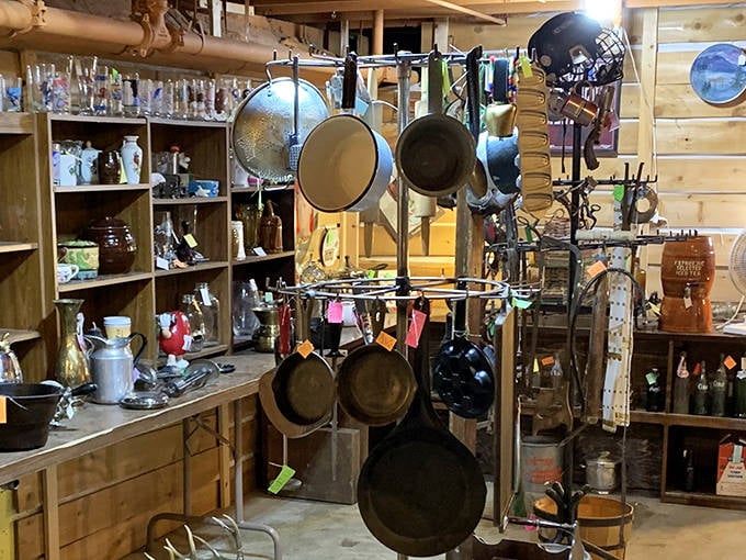 Cast iron paradise! These seasoned beauties hang like culinary constellations, each pan telling stories of countless family dinners and frontier feasts.
