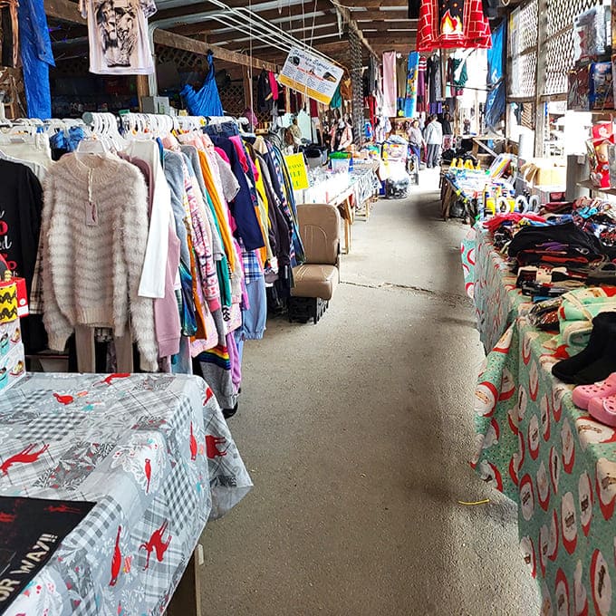 Colorful clothing aisles stretch into the distance at Bill's Flea Market, where vintage treasures and modern apparel await bargain hunters.