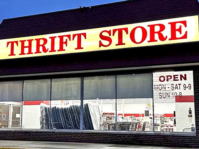 The bold red lettering announces this temple of thrift to passing traffic, where savvy shoppers know extended hours mean more time for treasure hunting.