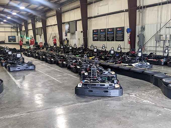The fleet of go-karts awaits their next drivers, lined up and ready to transform ordinary people into speed-obsessed racing champions.