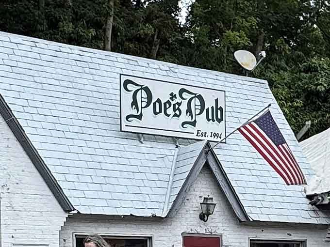 That charming white cottage exterior promises literary adventures and seriously good eats inside Poe's Pub.
