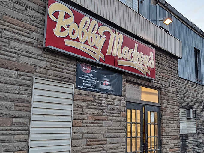 The iconic red and gold sign beckons like a siren call, promising country music and possibly paranormal encounters.