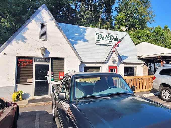 That charming white cottage exterior promises literary adventures and seriously good eats inside Poe's Pub.