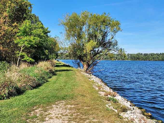 That peaceful waterside path is calling your name louder than your couch ever could on Sunday morning.