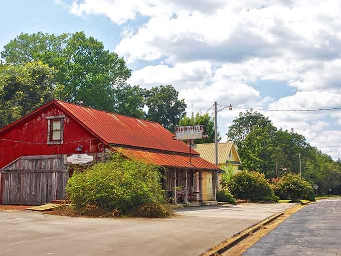 The Springfield Store stands as a colorful sentinel of small-town commerce, its vibrant red exterior a bold declaration that some traditions refuse to fade away.