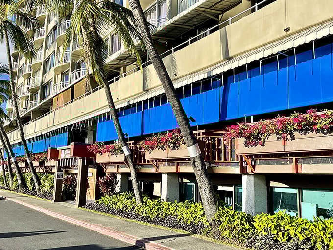 Palm trees and bougainvillea frame this waterfront gem, where Hawaiian breezes carry the scent of grilled fish and whispered promises of dessert perfection.