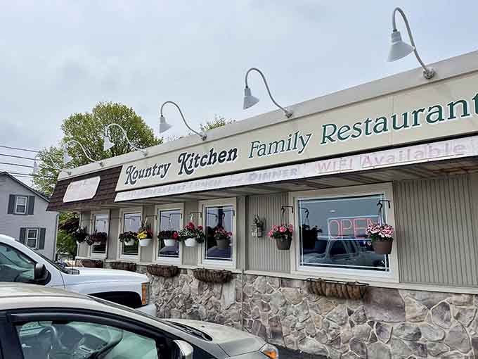 That charming stone foundation and those cheerful flower baskets aren't trying to impress anyone, they just naturally succeed.