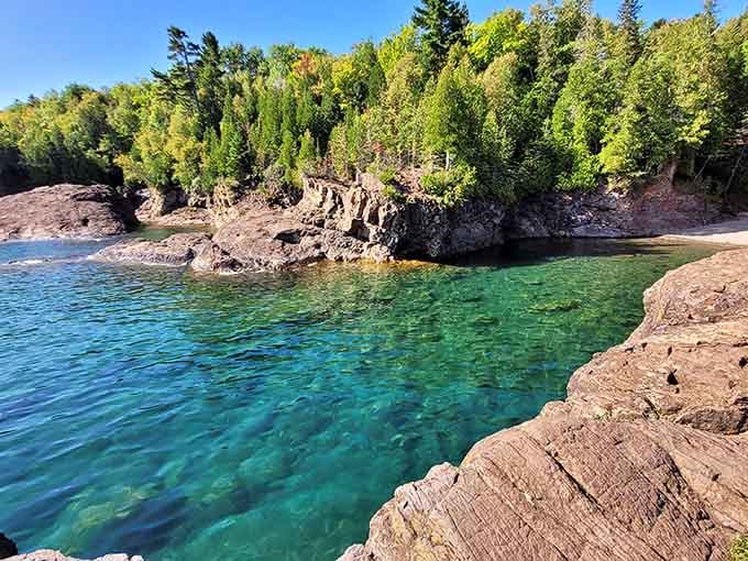 That emerald water against ancient volcanic rock creates a color combination that makes tropical destinations look positively ordinary.