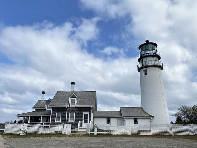 The classic New England lighthouse trio: white tower, keeper's house, and that endless blue sky overhead.