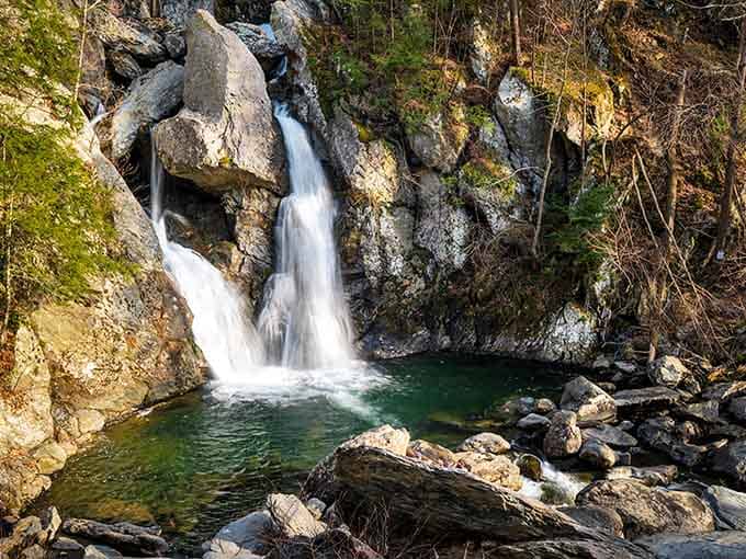 Water splits around ancient boulders like nature's own choose-your-own-adventure story, creating twin cascades of pure magic.