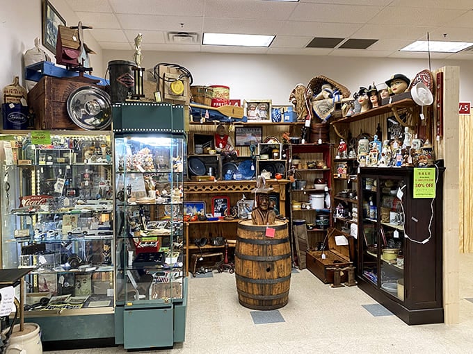 Floor-to-ceiling treasures fill this vendor space, where glass display cases protect smaller collectibles while wooden barrels add rustic charm.