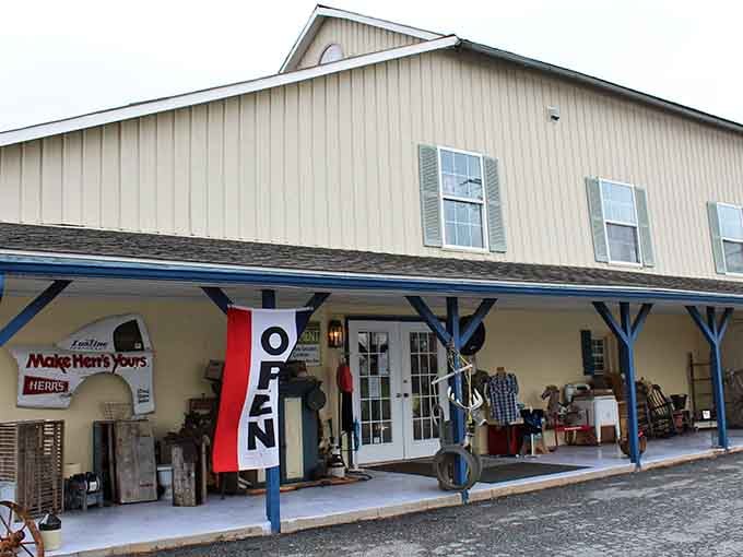The welcoming country-style exterior of Peach Bottom Consignment invites shoppers with its charming porch and "OPEN" flag.