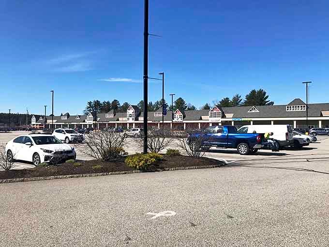 The sprawling parking lot reveals Tanger's true scale, with its colonial-inspired buildings stretching across the horizon like a Revolutionary-era village dedicated to the pursuit of discounts.