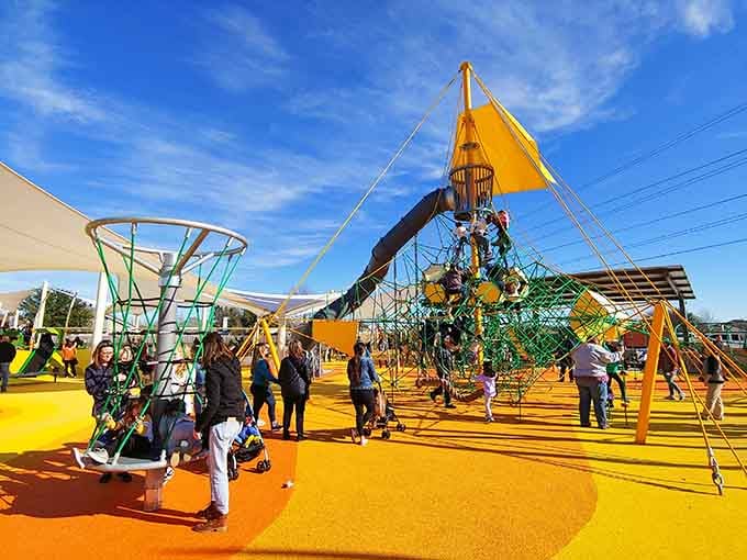 Vibrant climbing structures rise like a carnival came to stay, offering adventures for every age and ability level.
