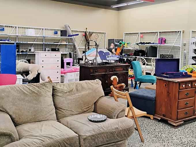 A well-loved sofa sits among an eclectic mix of furniture, creating the perfect hunting ground for budget-conscious decorators.