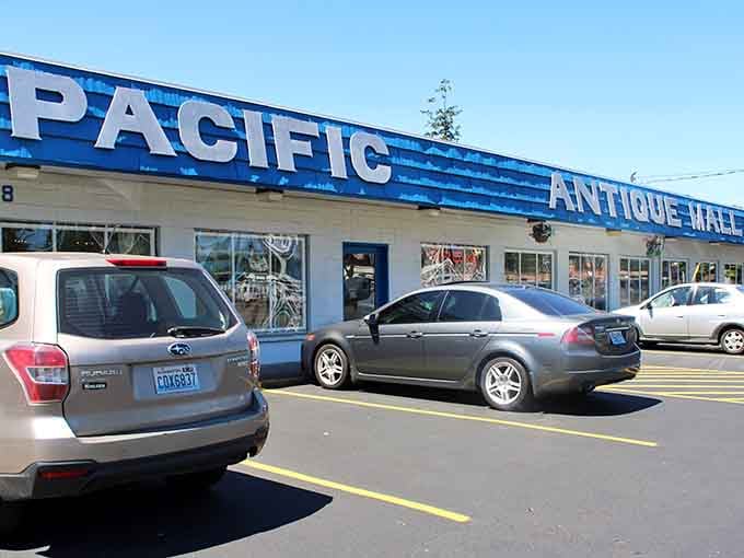 The iconic blue and white facade of Pacific Antique Mall stands as a beacon for treasure hunters. Modern cars parked outside hint at the timeless treasures waiting within.