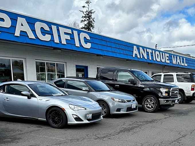 The iconic blue and white facade of Pacific Antique Mall stands as a beacon for treasure hunters. Modern cars parked outside hint at the timeless treasures waiting within.
