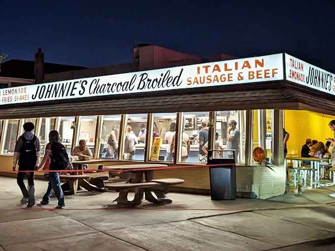 That vintage sign glowing against the night sky isn't just advertising, it's a promise being kept nightly.