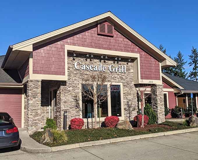 Meticulous landscaping frames Cascade Grill's distinctive architecture, creating an inviting first impression that hints at the culinary excellence within.