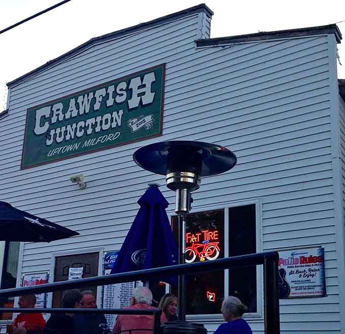 Evening diners enjoy the patio as the neon "Fat Tire" sign glows, signaling that good times and great food are happening right now.