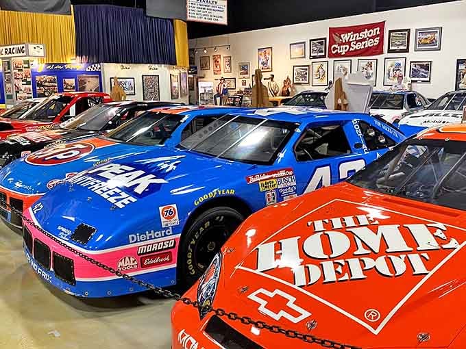 Iconic NASCAR race cars showcase decades of motorsport evolution, with their vibrant liveries and sponsor logos telling stories of American racing history.
