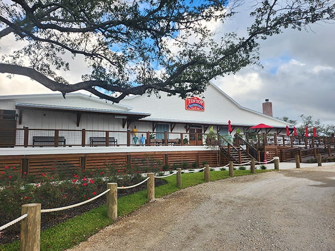 That welcoming white exterior and those cheerful red umbrellas signal you've arrived at coastal Alabama's seafood paradise.