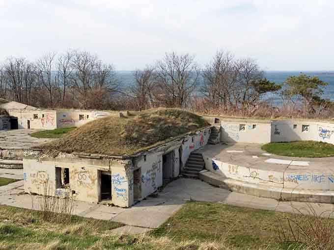 The weathered gun emplacements stand ready for battles that will never come, now hosting picnickers instead of soldiers with much better results.