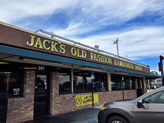 The "AND STILL FLIPPIN'" banner isn't just cute wordplay—it's a declaration of burger perseverance in an age when restaurants change concepts faster than Florida weather changes moods.