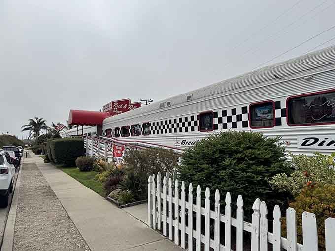 Classic diner architecture meets coastal California charm, complete with a white picket fence that says "welcome home."