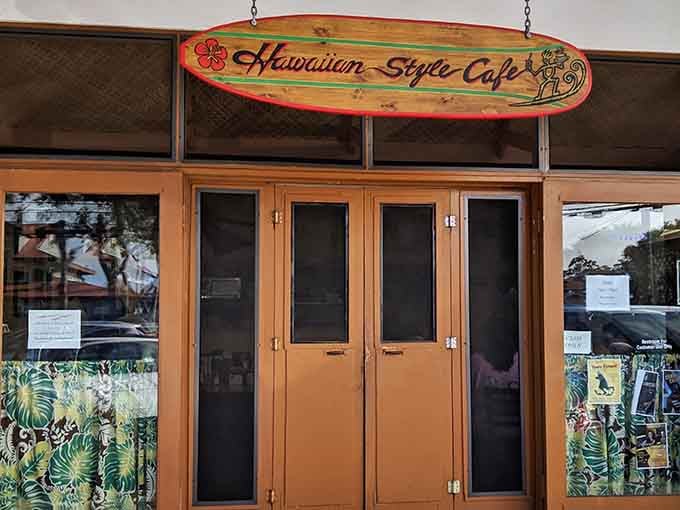 The surfboard sign says it all &ndash; this isn't just breakfast, it's an island tradition hanging above those wooden doors, promising culinary adventures within.