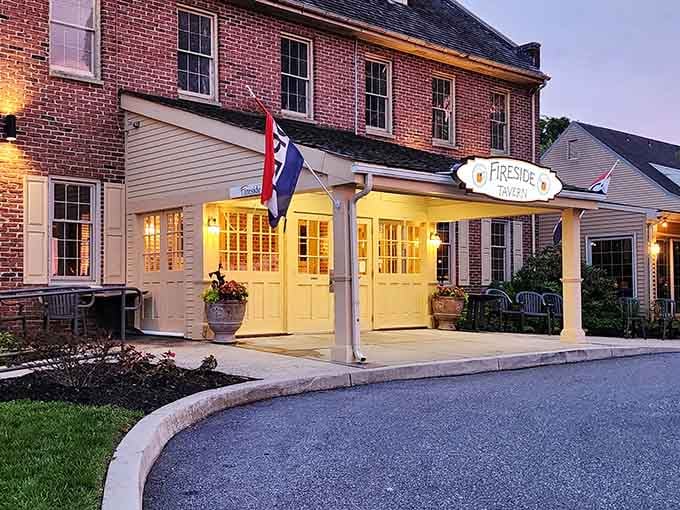 The golden glow of Fireside Tavern's entrance at dusk feels like a warm invitation from an old friend who happens to be an exceptional cook.