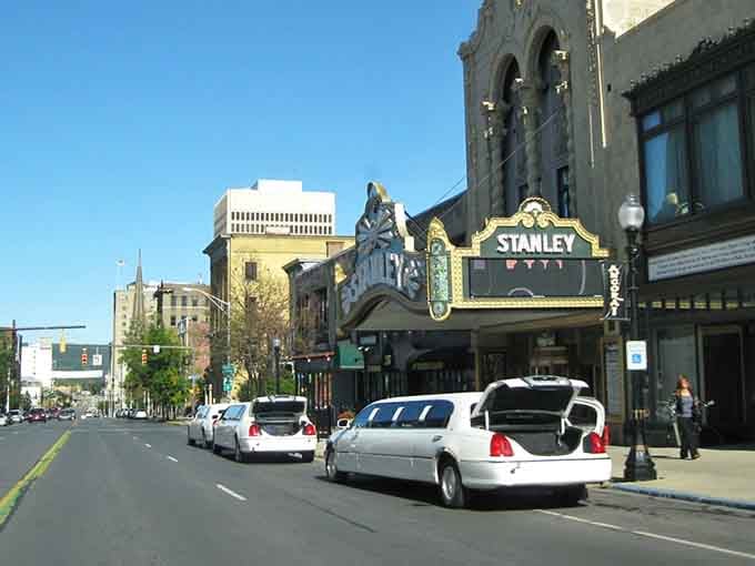 The iconic Stanley Theatre marquee brightens Genesee Street, a cultural beacon where Broadway shows cost less than a Manhattan cocktail and parking doesn't require therapy afterward.