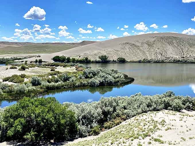Where desert meets oasis! The surreal landscape of Bruneau Dunes creates nature's perfect mirror, reflecting both sky and sand in crystalline lakes.