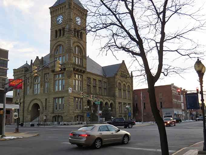 Historic charm meets everyday life in downtown Bluffton, Indiana, where the clock watches over passing cars and conversations daily.