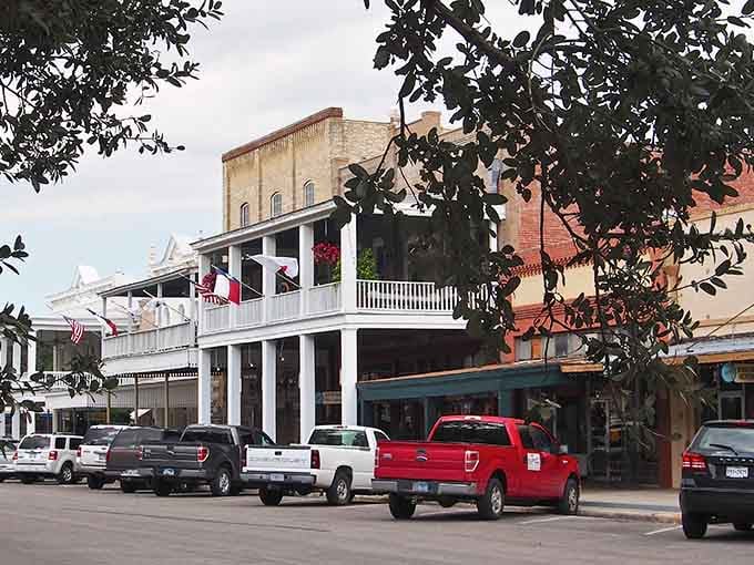 Historic storefronts line Goliad's downtown square, where time moves slower and nobody minds one bit.