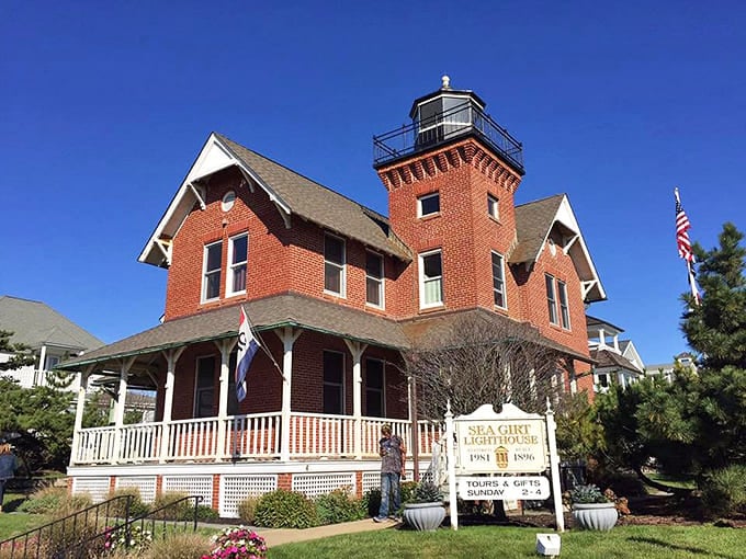 The red brick exterior and wraparound porch make this look more like Grandma's house than a maritime safety beacon.