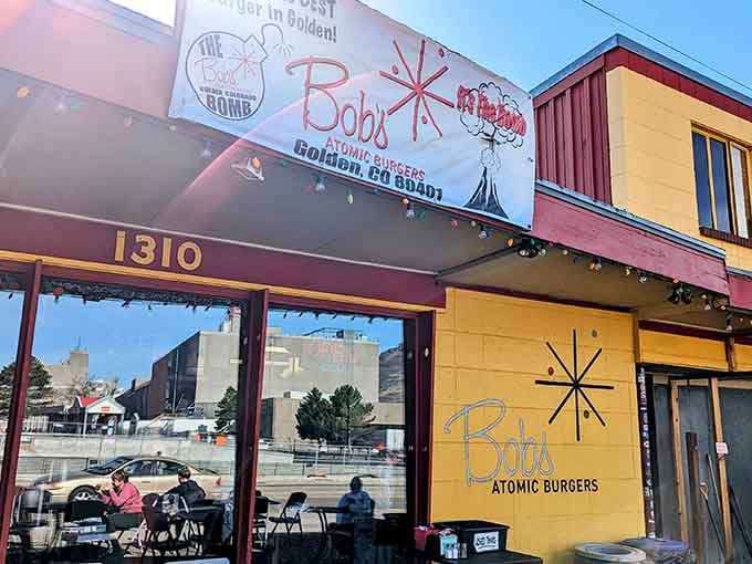 That bright yellow exterior and iconic starburst logo practically glow with 1950s optimism and burger-fueled dreams.