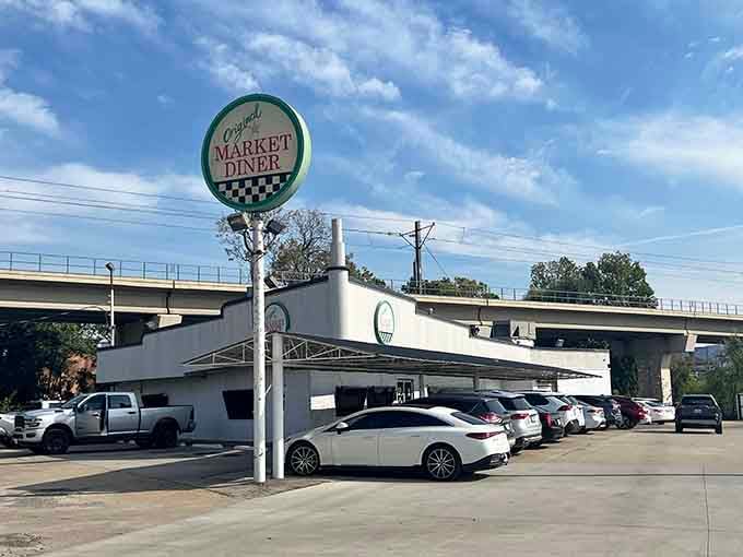 That classic diner sign rising above the parking lot is your beacon to breakfast bliss and retro perfection.