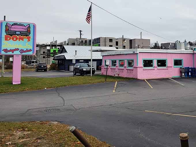The American flag waves proudly above this pastel palace, where patriotism tastes like vanilla shakes and crispy fries.